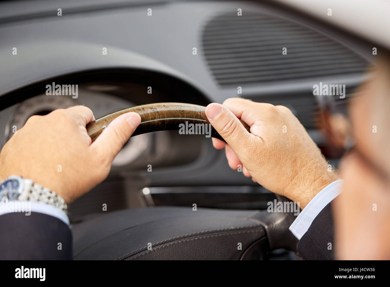 senior businessman hands driving car Stock Photo - Alamy