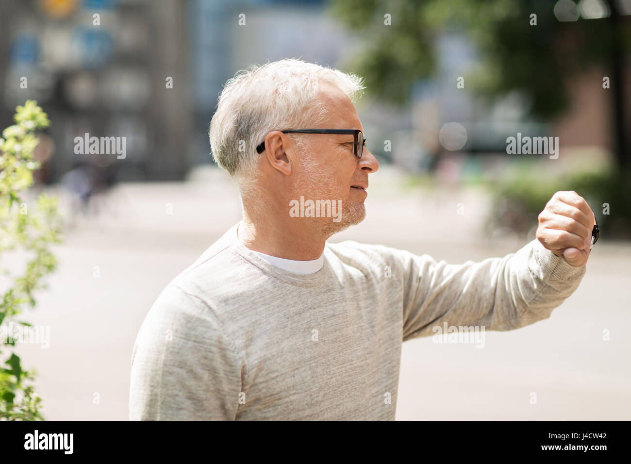 senior man checking time on his wristwatch Stock Photo - Alamy