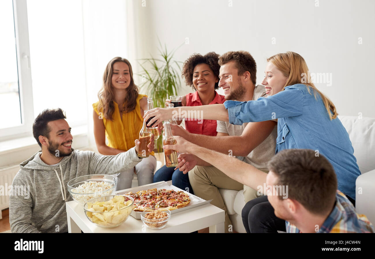 friends having party and clinking drinks at home Stock Photo - Alamy