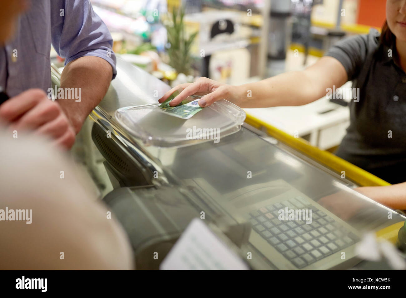 couple paying money at grocery store cash register Stock Photo - Alamy