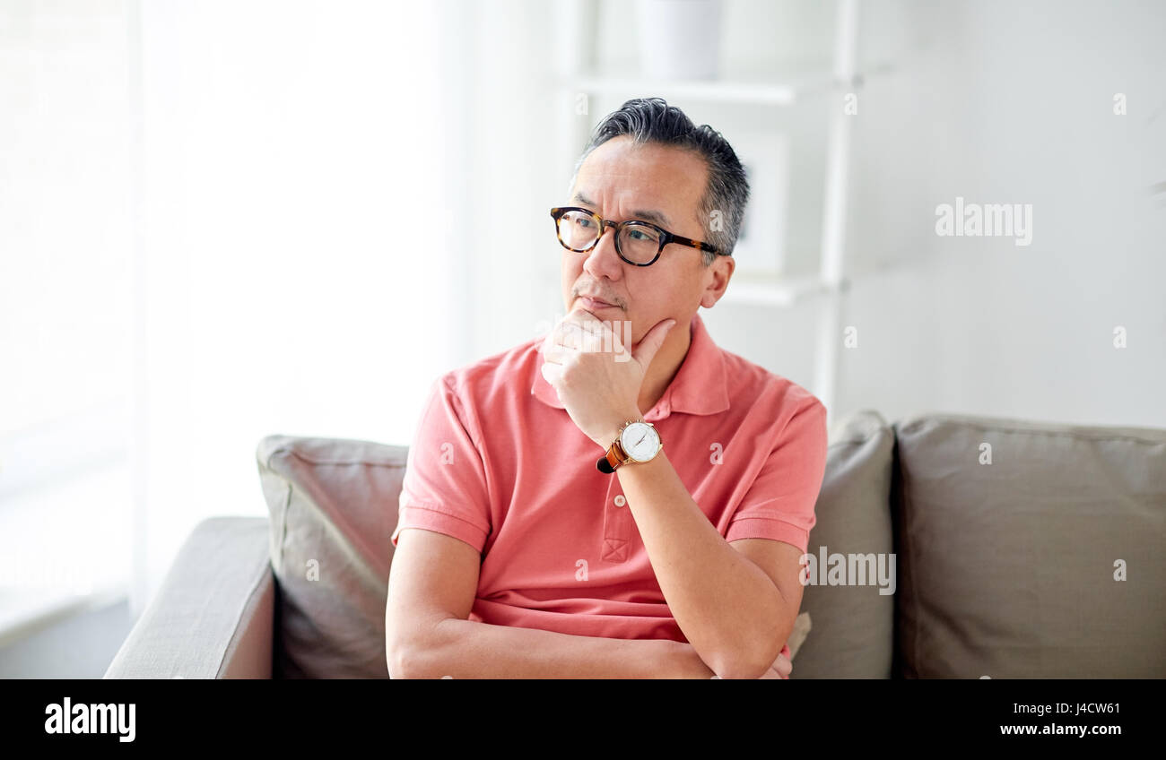 asian man thinking at home Stock Photo - Alamy