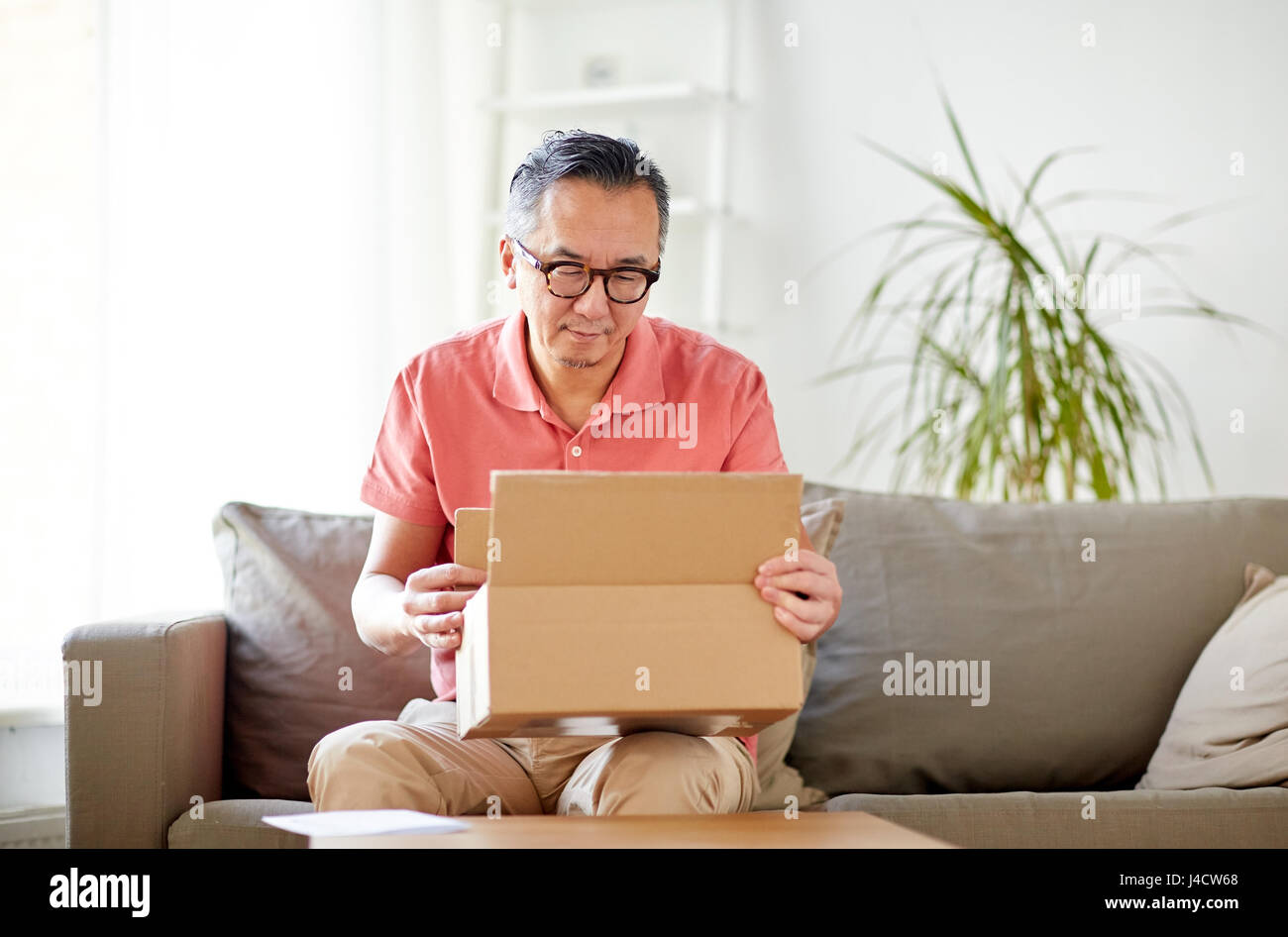 man opening parcel box at home Stock Photo - Alamy