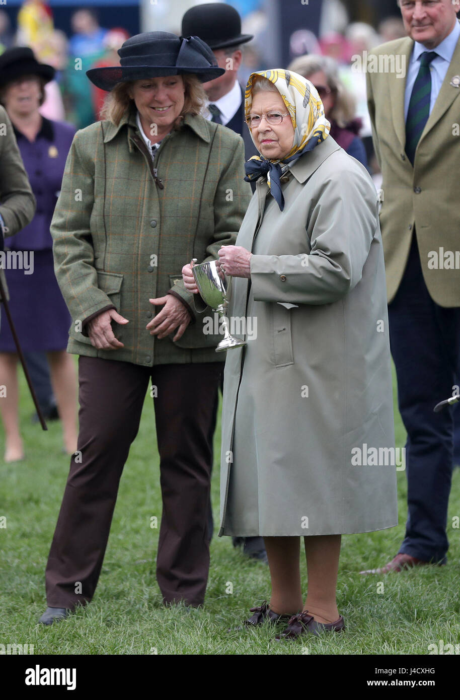 Queen Elizabeth II is presented with a trophy, after her horse Barber's ...