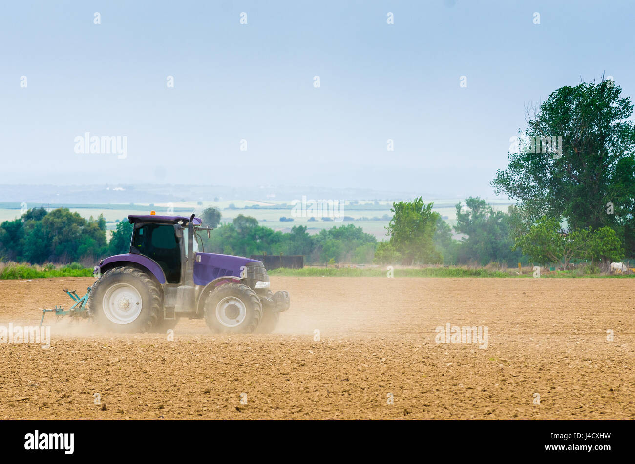 Tractor preparing land for sowing Stock Photo - Alamy
