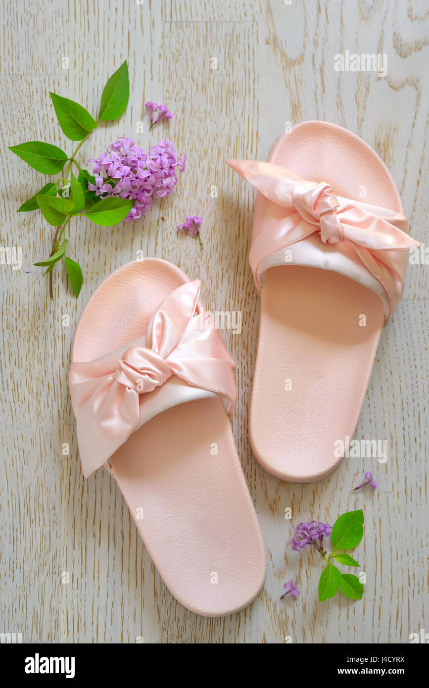 Rose pink woman slippers on wooden background Stock Photo - Alamy