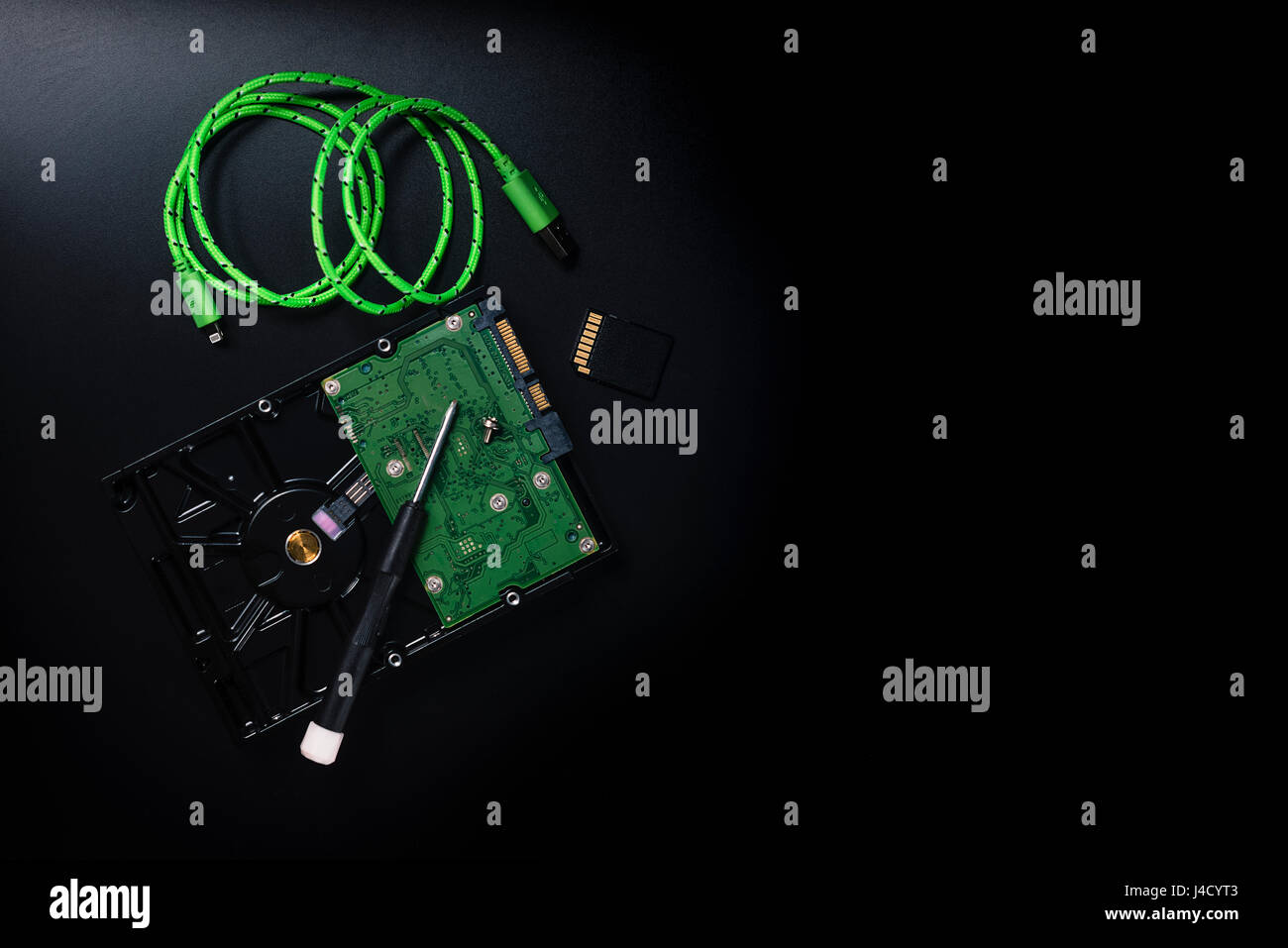 flat lay of hard disk, cable, internal, screwdriver, sd memory card on ...