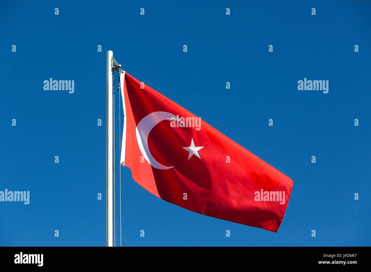 National flag of Turkey on a flagpole in front of blue sky Stock Photo ...