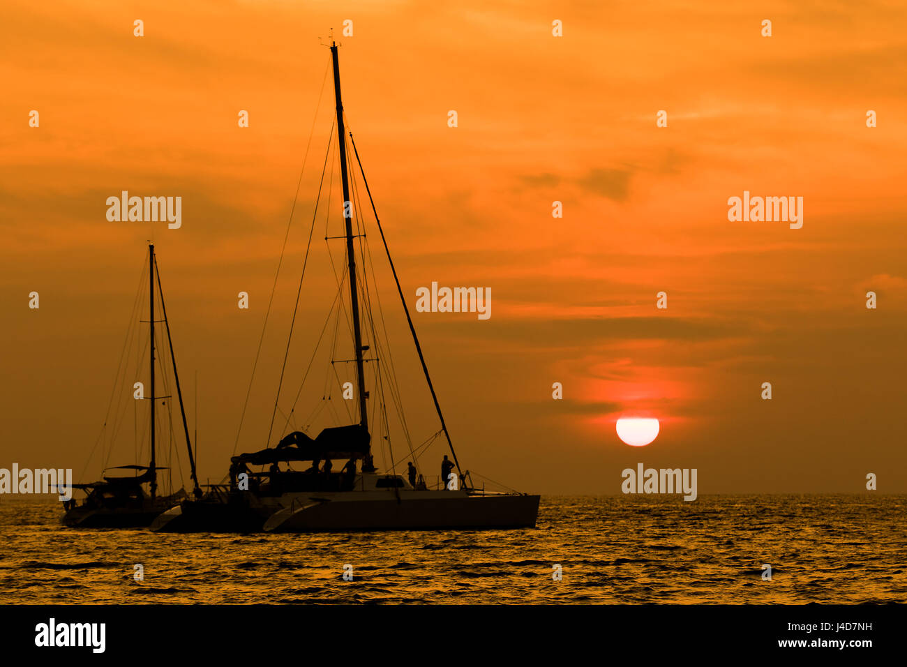beautiful natural scenic of sun set behind sailing boat Stock Photo - Alamy