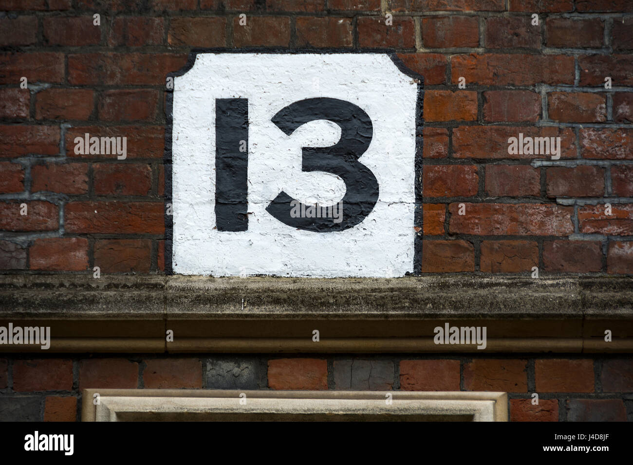 Number thirteen hand painted on plaster background Stock Photo - Alamy