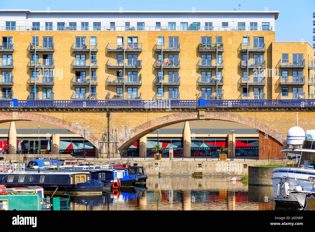 Waterside apartments and viaduct at Limehouse Basin Marina in London ...