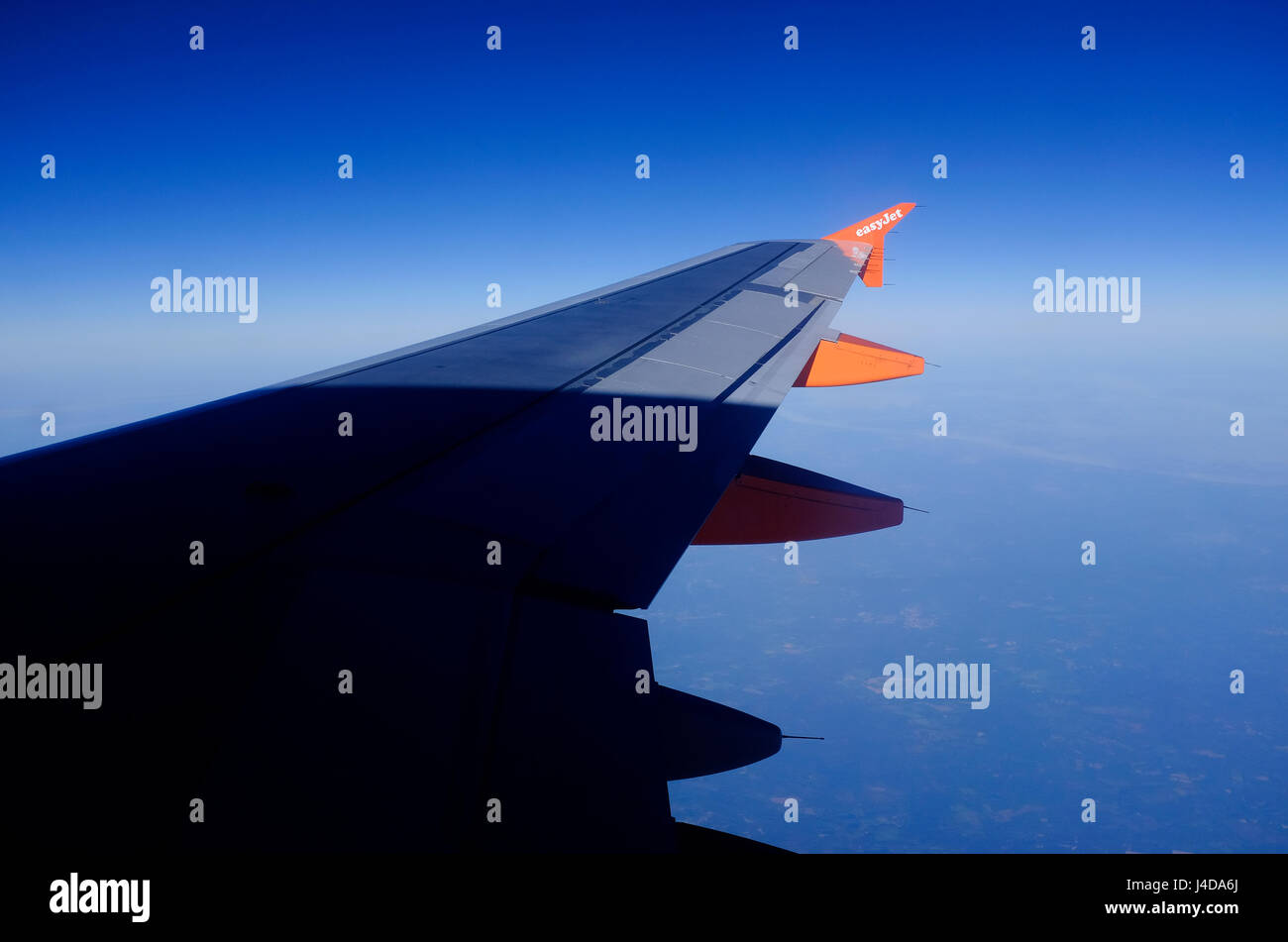 easyjet aircraft wing and blue sky background Stock Photo - Alamy