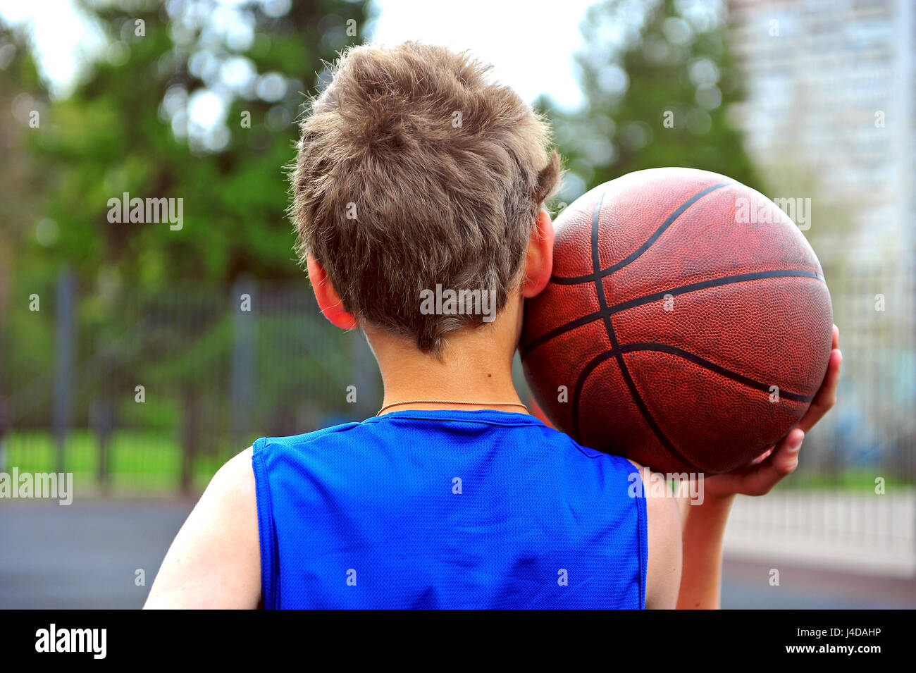Back view of an young basketball player with a ball Stock Photo - Alamy