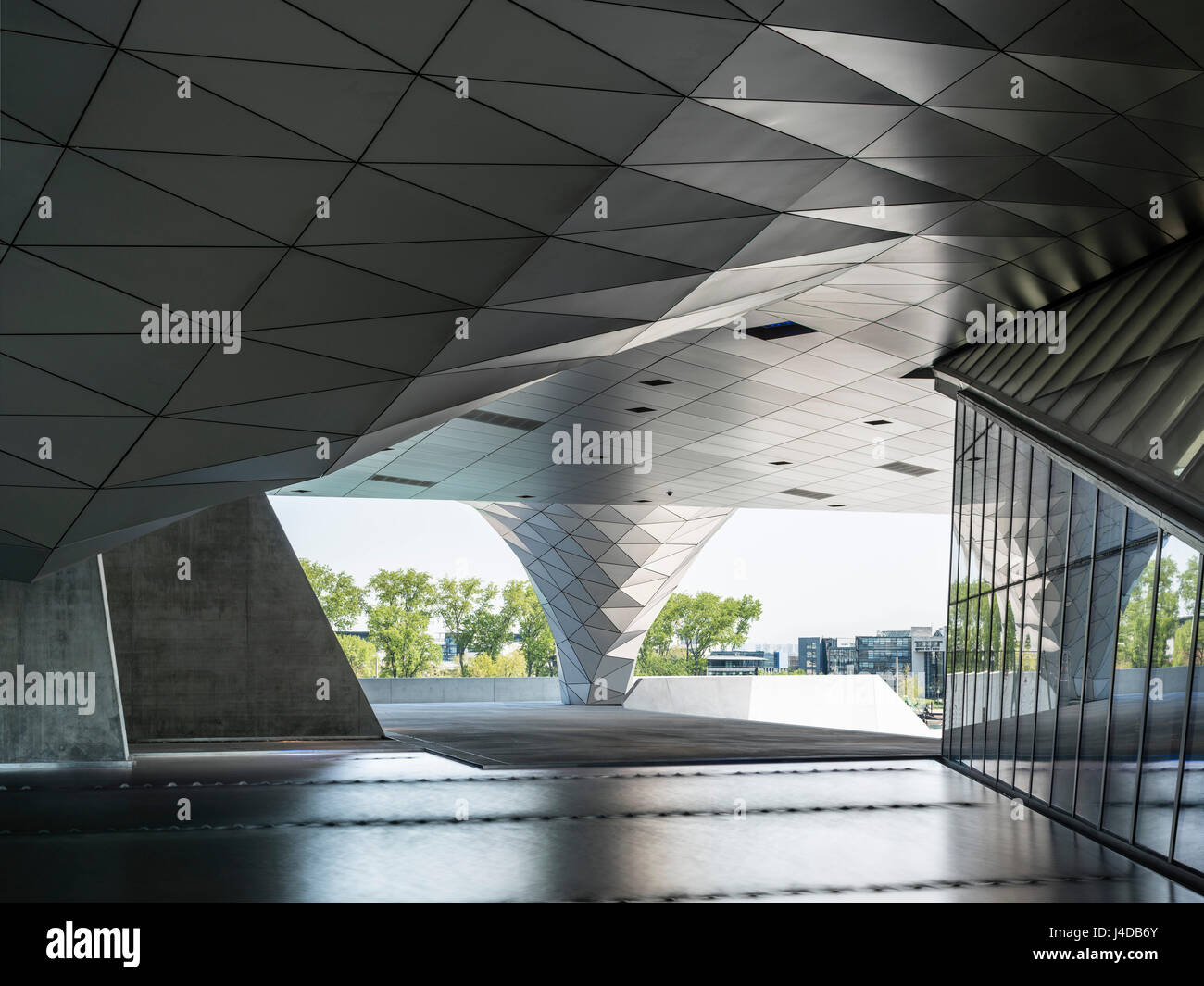 View of the public space underneath the building with illuminated pool ...
