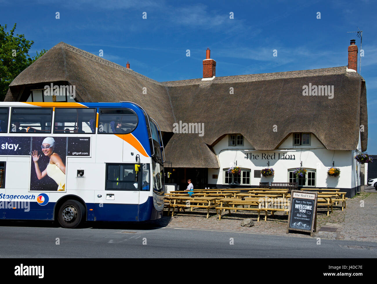 Bus stopping outside the Red Lion pub, Avebury, Wiltshire. England UK ...