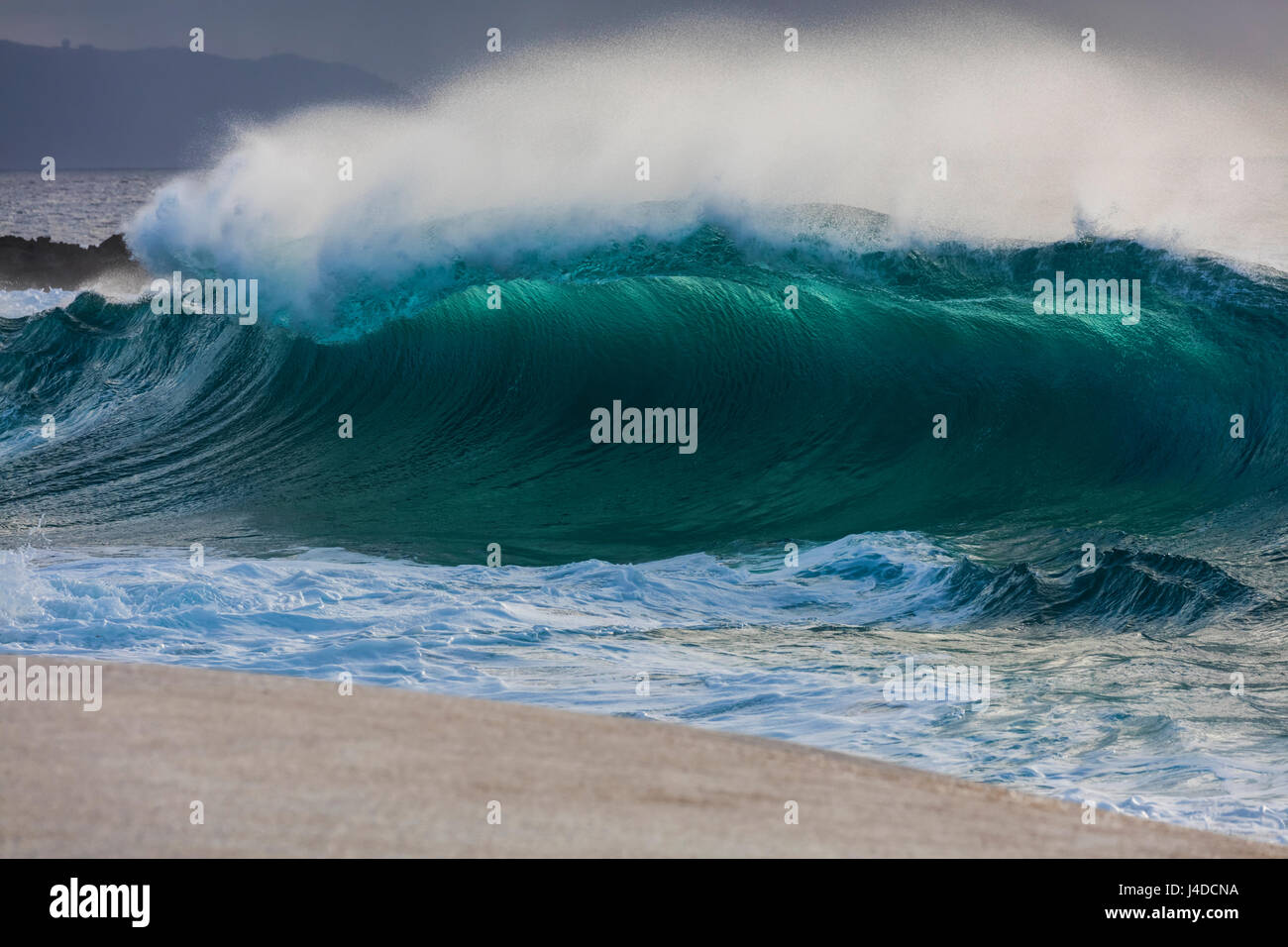 A large shorebreak wave in the evening at Keiki beach on the North ...