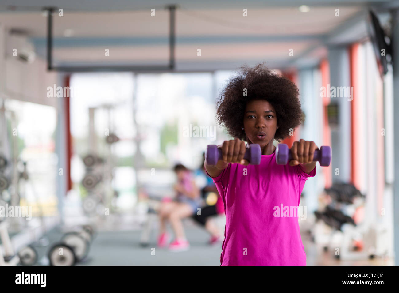 happy healthy african american woman working out in a crossfit gym on ...