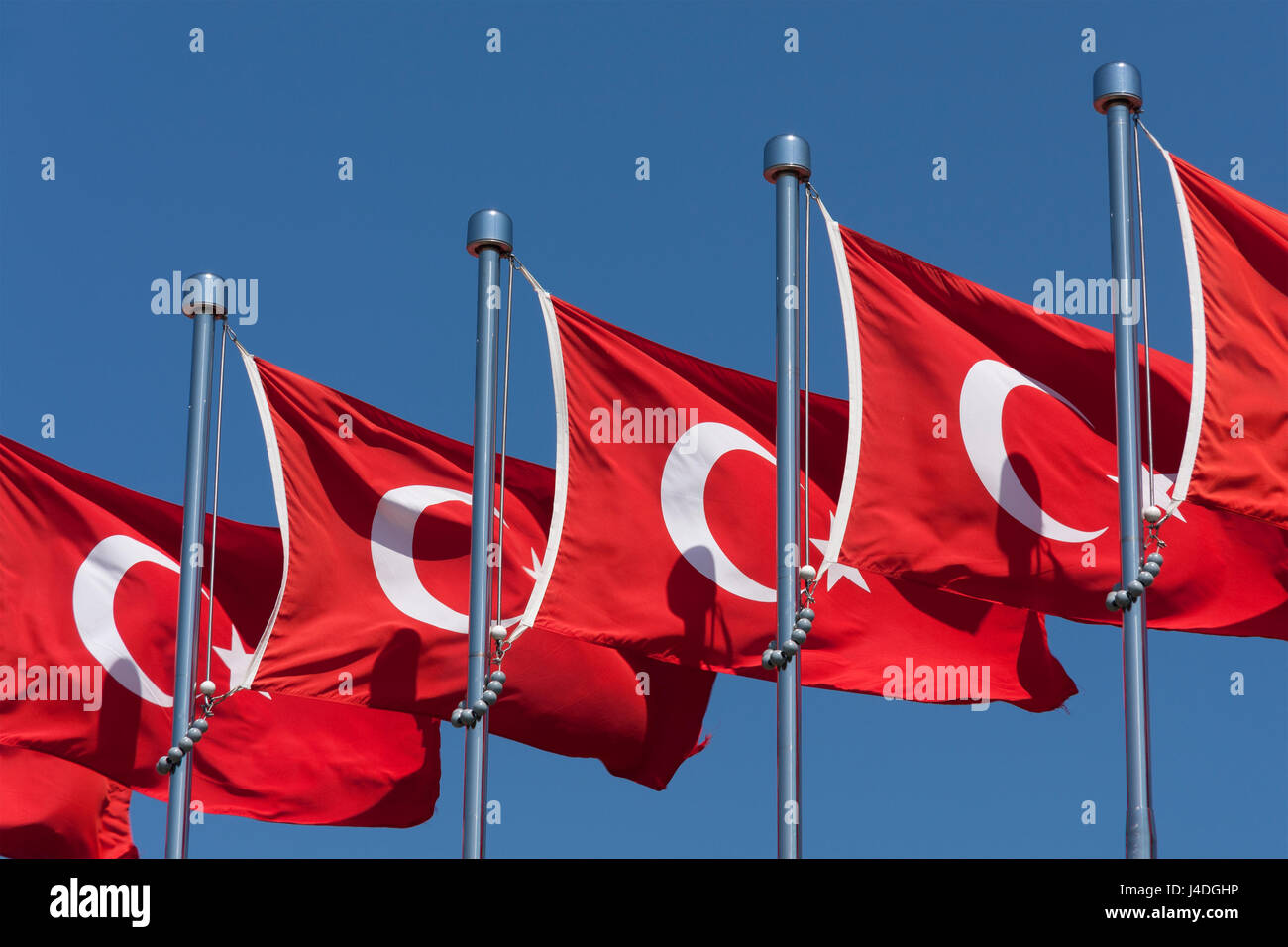 A row of Turkish flags flying against a blue sky Stock Photo - Alamy
