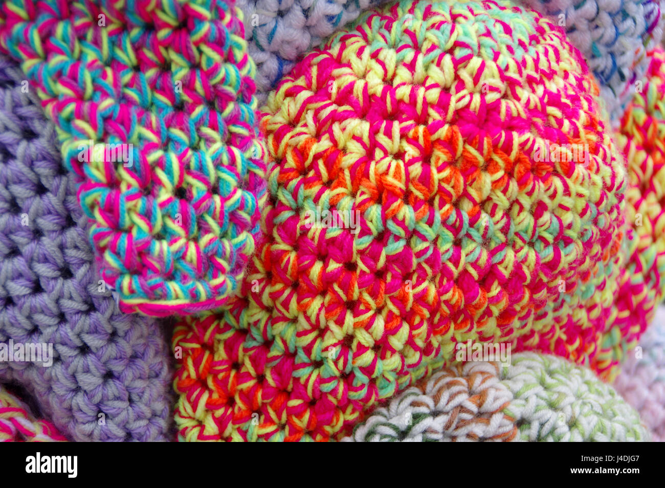 The handmade wool caps in variegated colors Stock Photo - Alamy