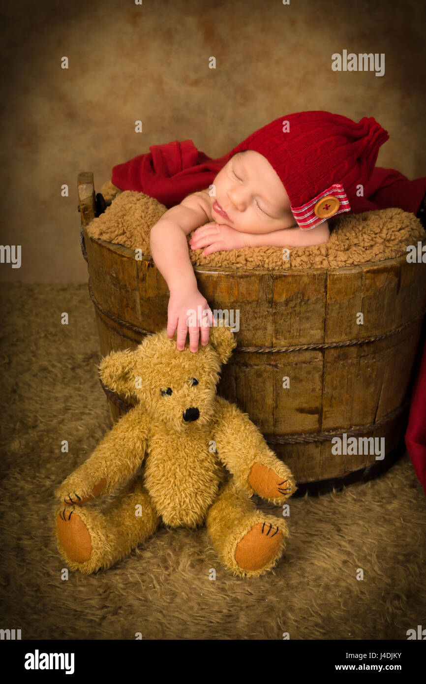 Newborn baby of mixed race sleeping in an antique wooden bucket Stock ...