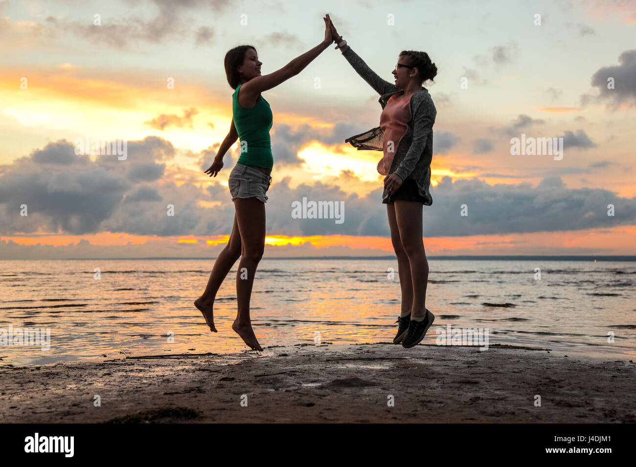Couple jumping into lake hi-res stock photography and images - Alamy