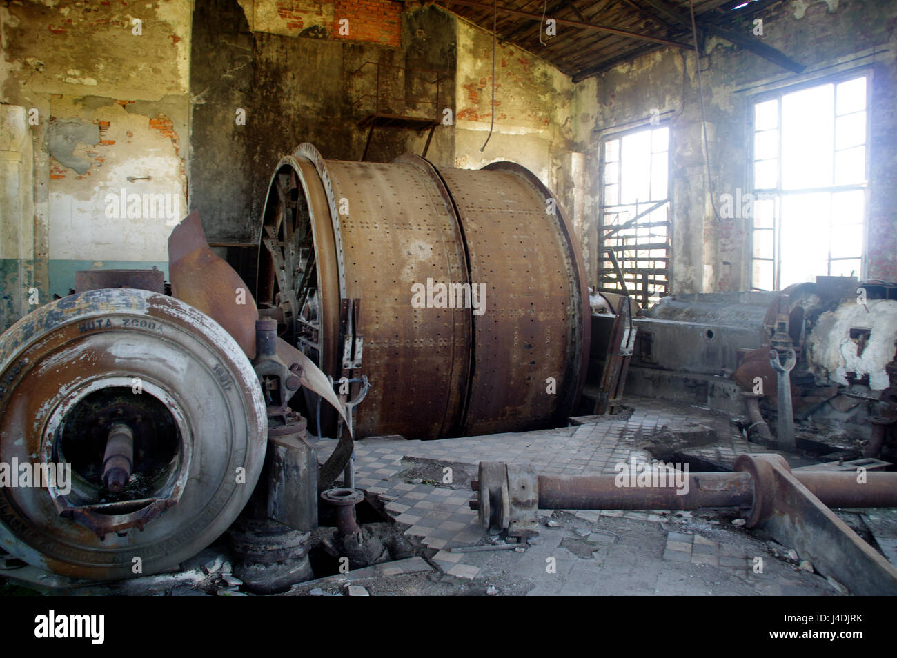 Big round destroyed machine with damaged engine in ruin of factory ...