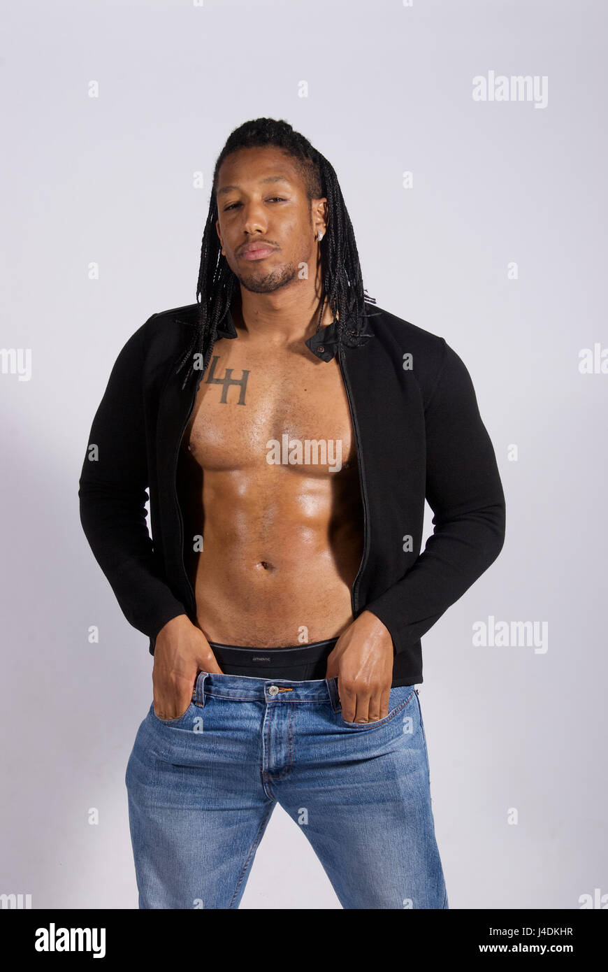 Strong fit black man in a studio with white background Stock Photo - Alamy