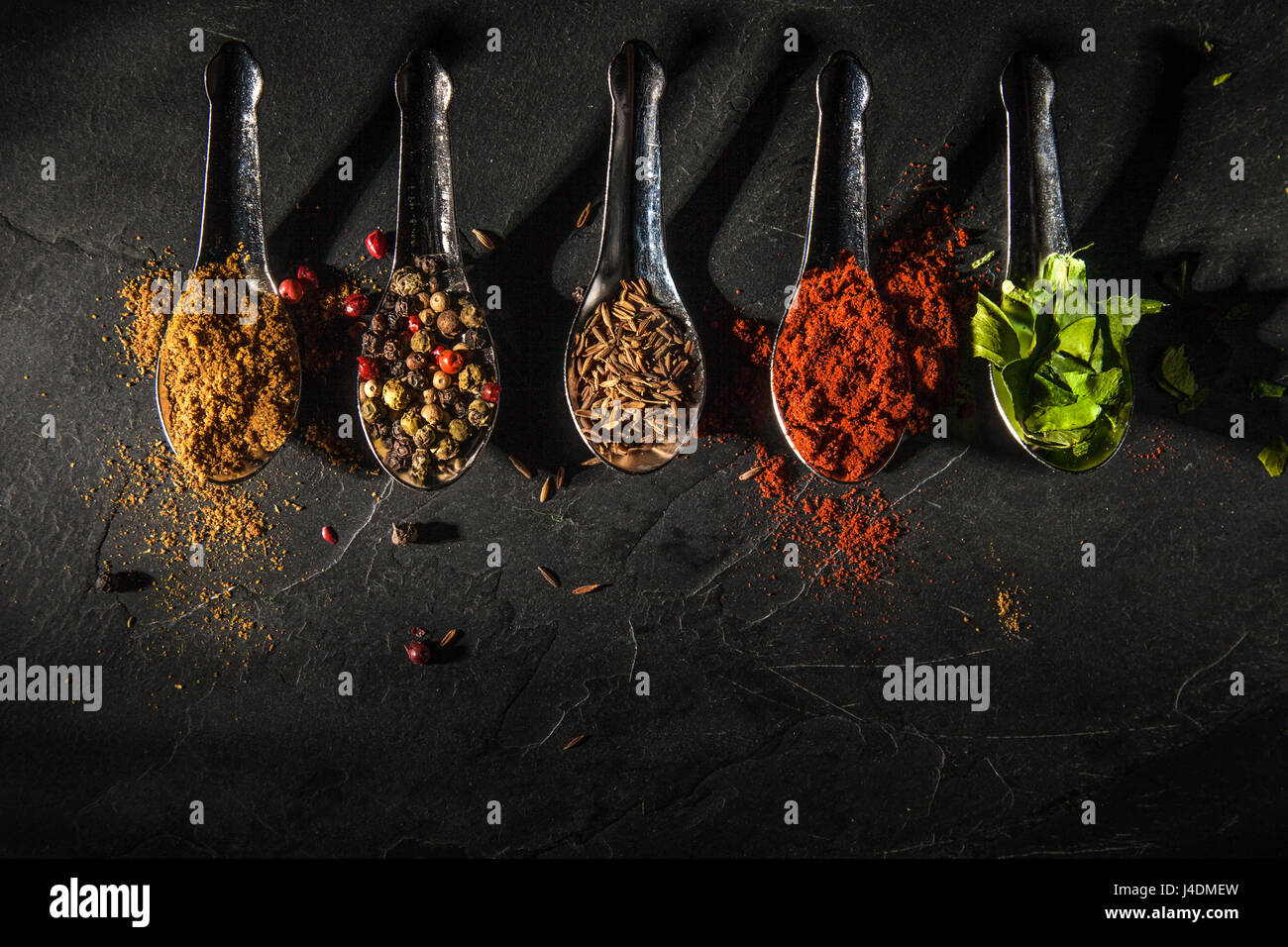 Five Spice spoons on slate background with shadow Stock Photo - Alamy