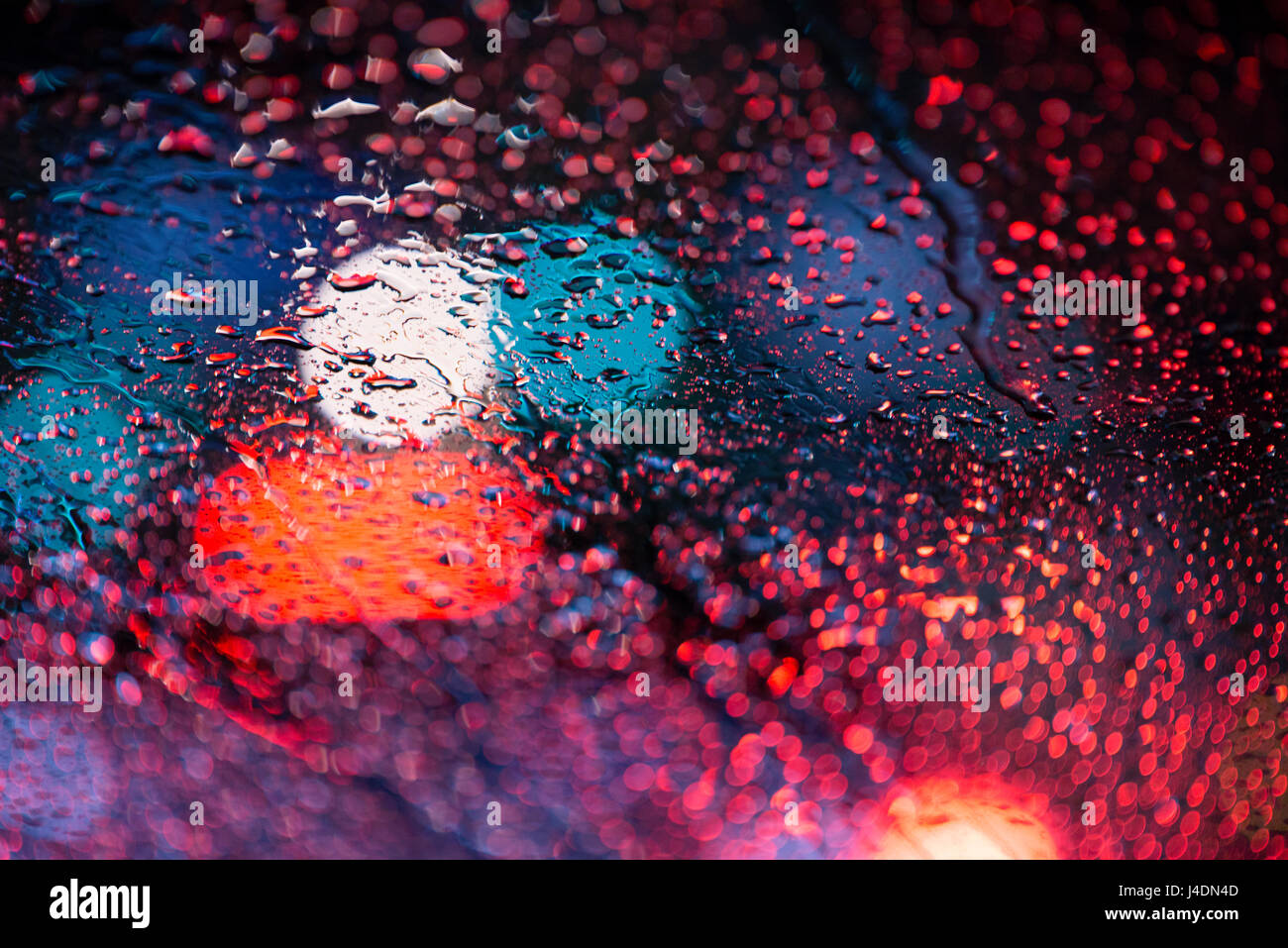 Raindrops on a window glass, night city lights at the background Stock ...