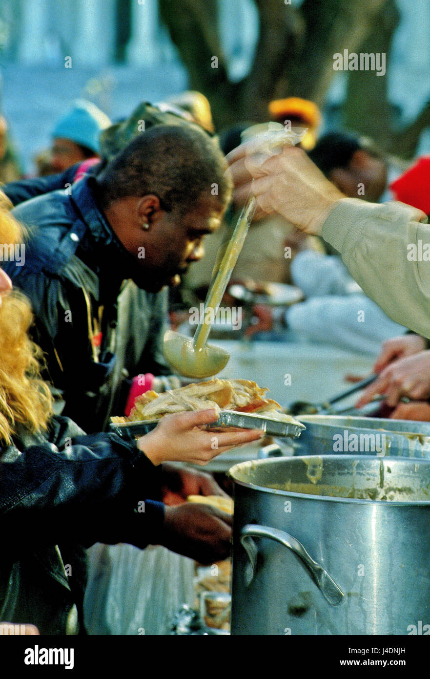 Homeless people are served thanksgiving dinner by members of the ...