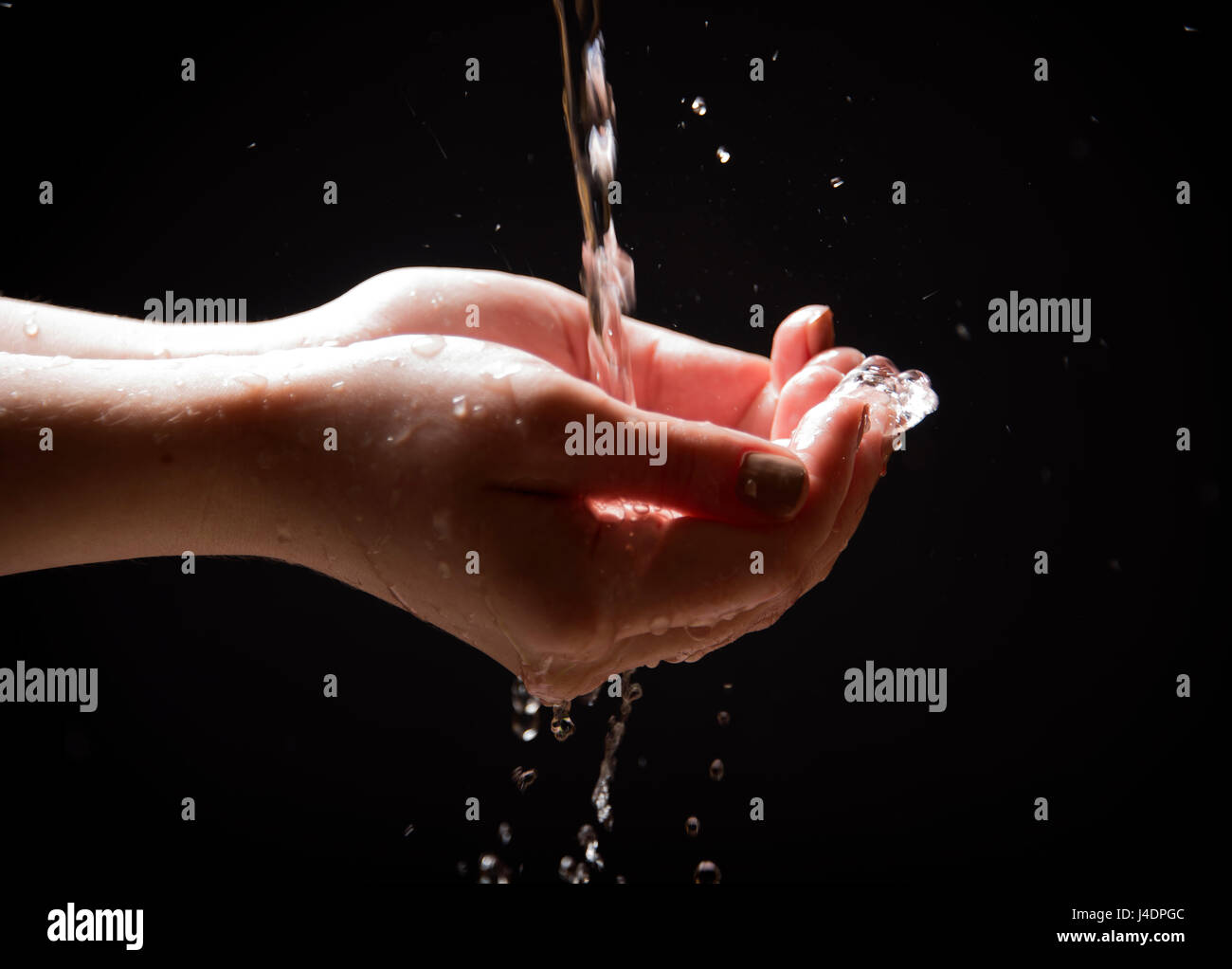 Water is poured into the palms of your hands Stock Photo - Alamy