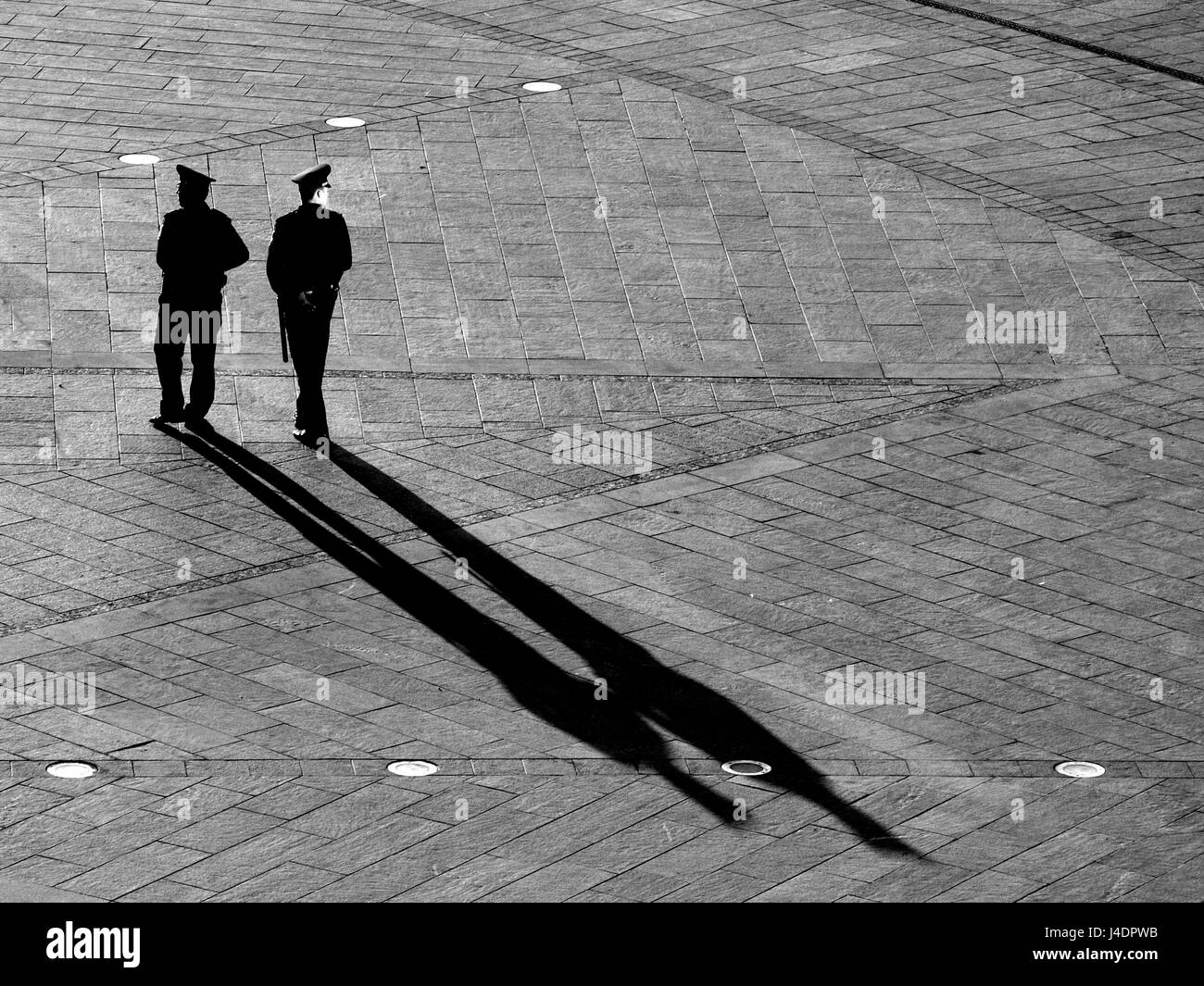 Two Ukrainian policemen, black silhouettes of men from whom stretch ...