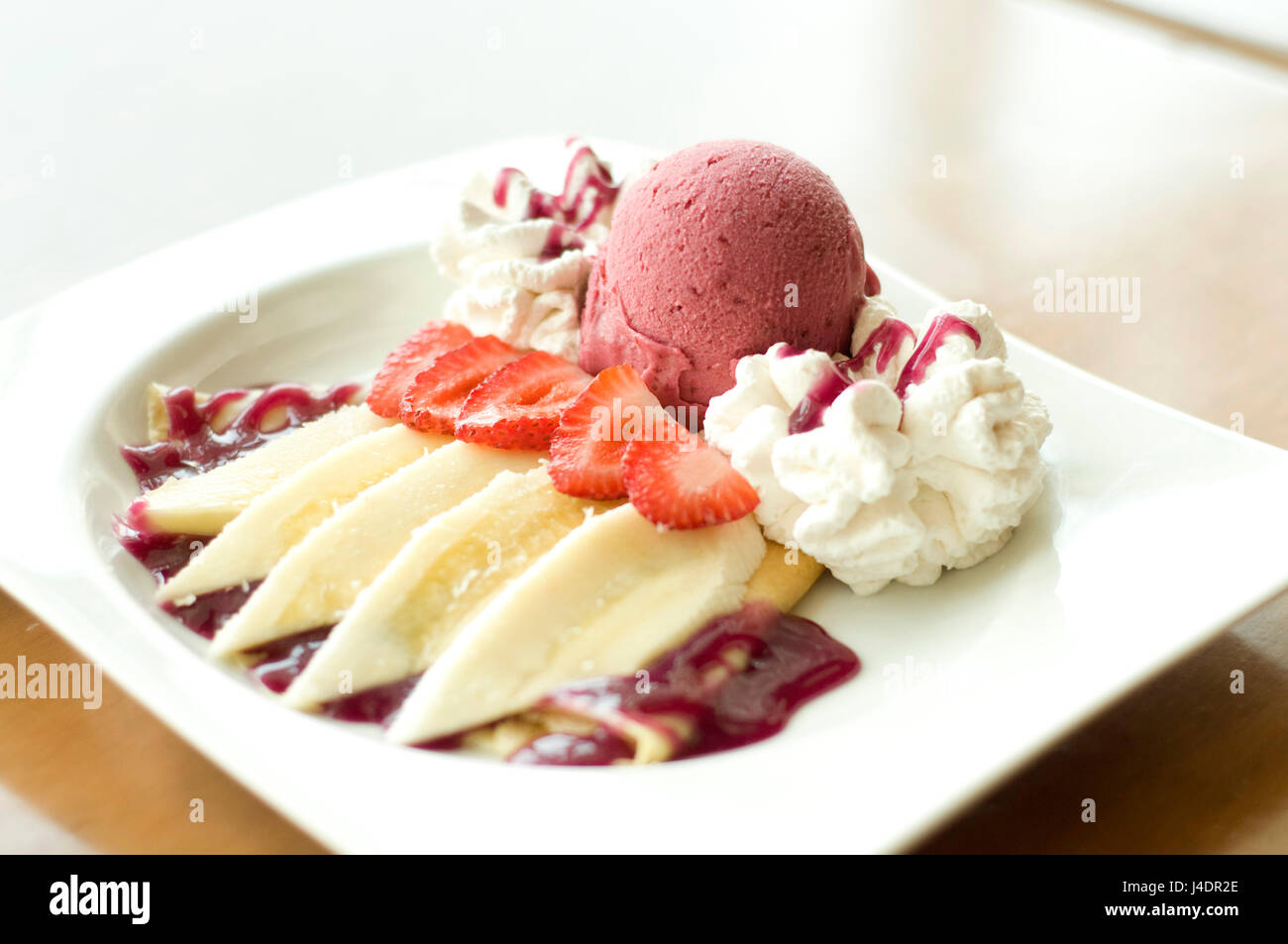 Crepes with fruit,syrup,whipped cream and ice cream Stock Photo - Alamy