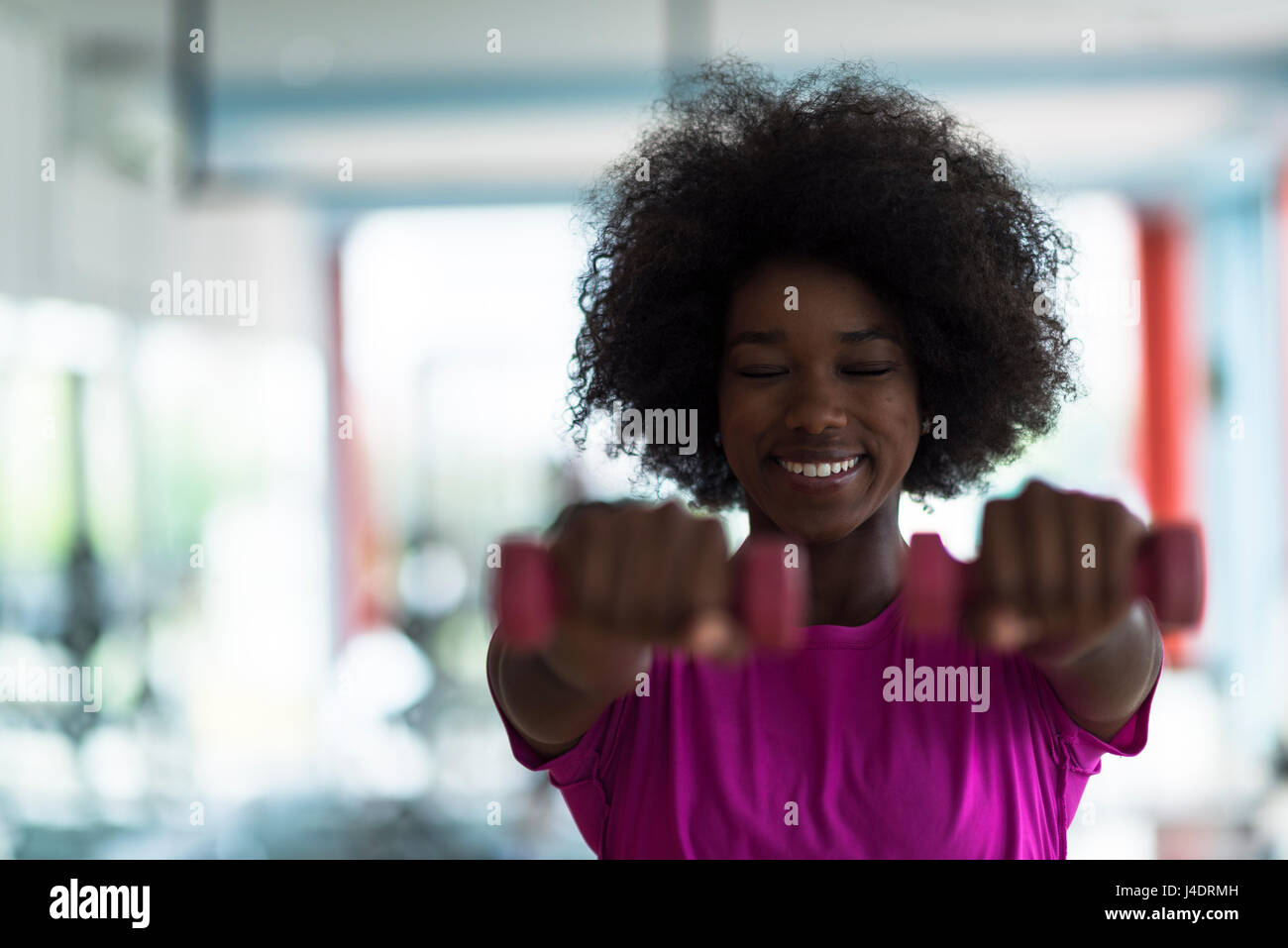 happy healthy african american woman working out in a crossfit gym on ...