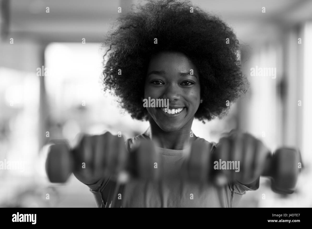happy healthy african american woman working out in a crossfit gym on ...