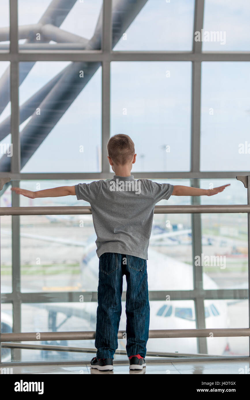 Boy flies with a plane at the airport, children's dreams Stock Photo ...