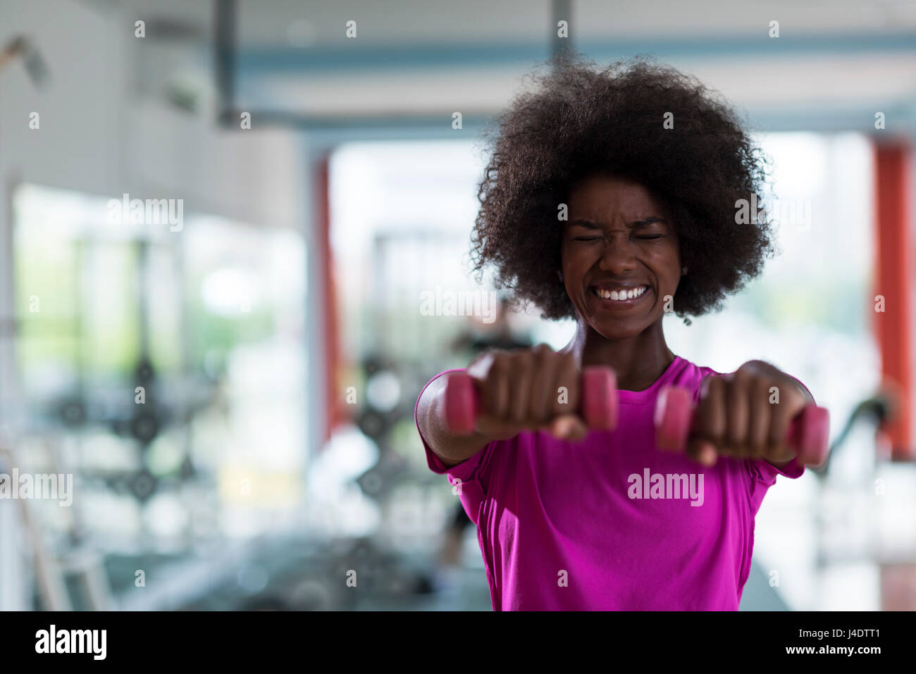 happy healthy african american woman working out in a crossfit gym on ...