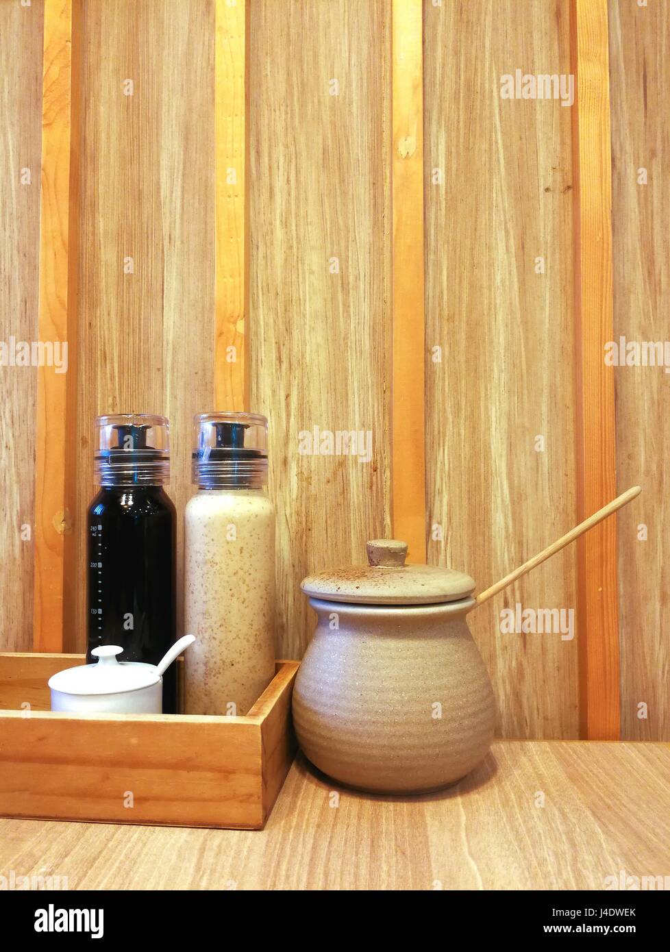 Bottles and jar of Japanese condiments on wooden background Stock Photo ...