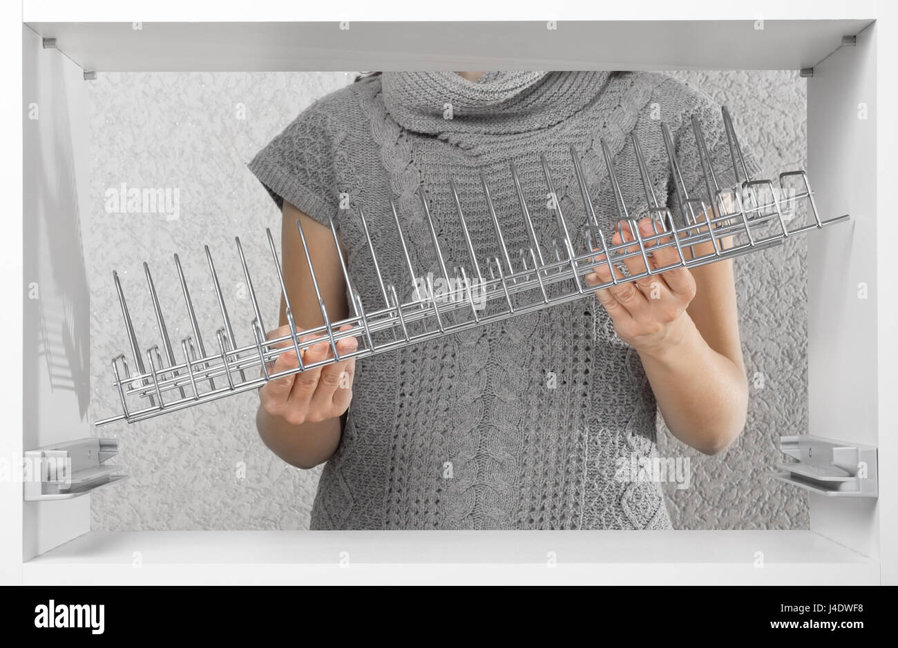 hands assembling dish rack inside kitchen cupboard Stock Photo - Alamy