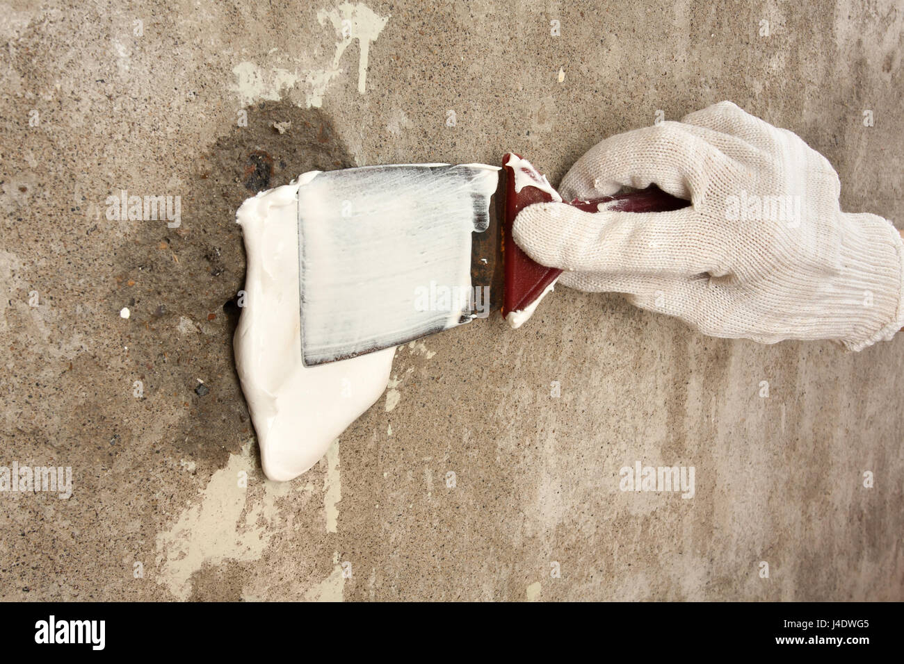 hand plastering surface of wall with spatula during repair Stock Photo ...