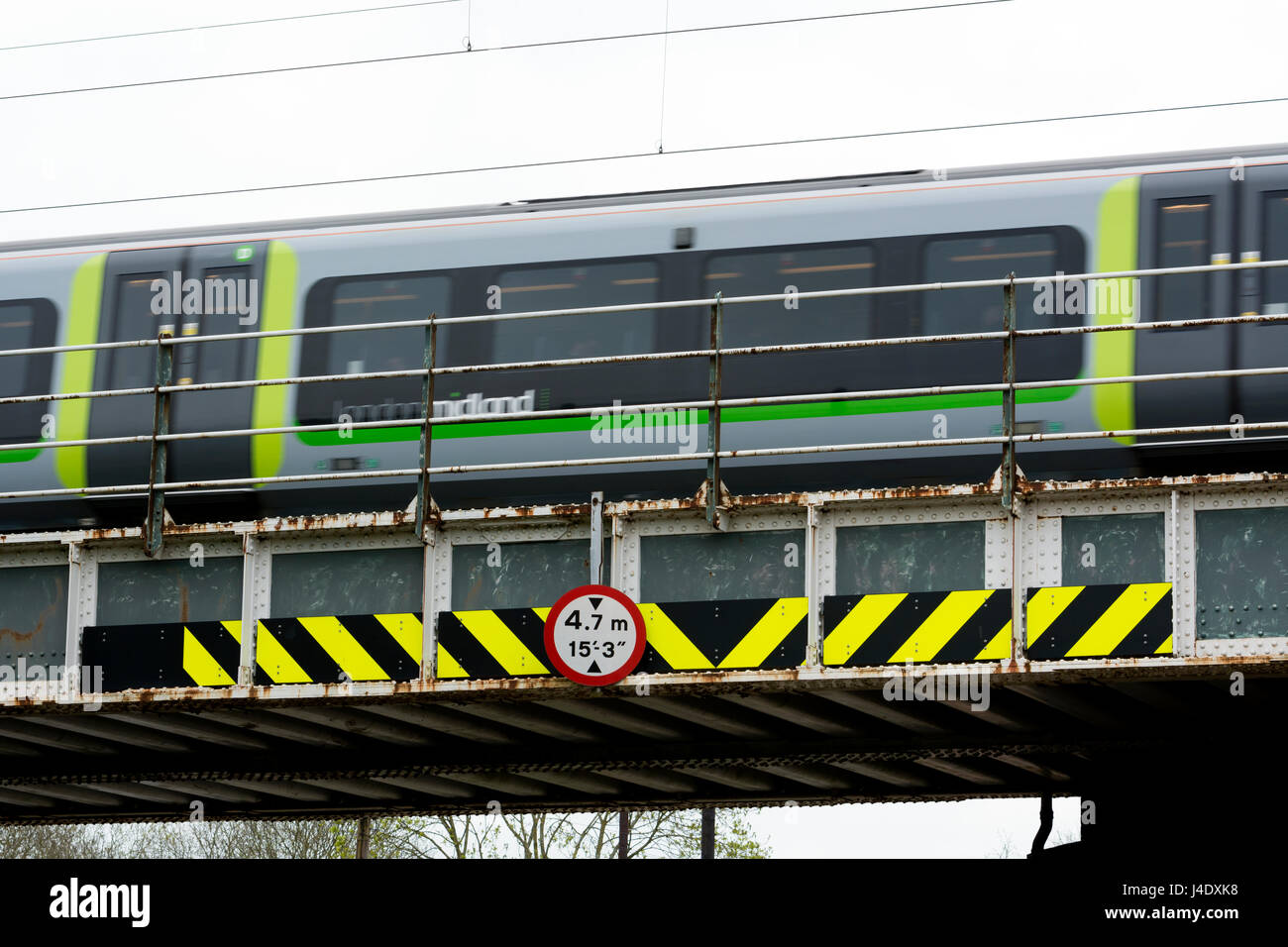 London Midland train crossing a railway bridge by Long Buckby station ...