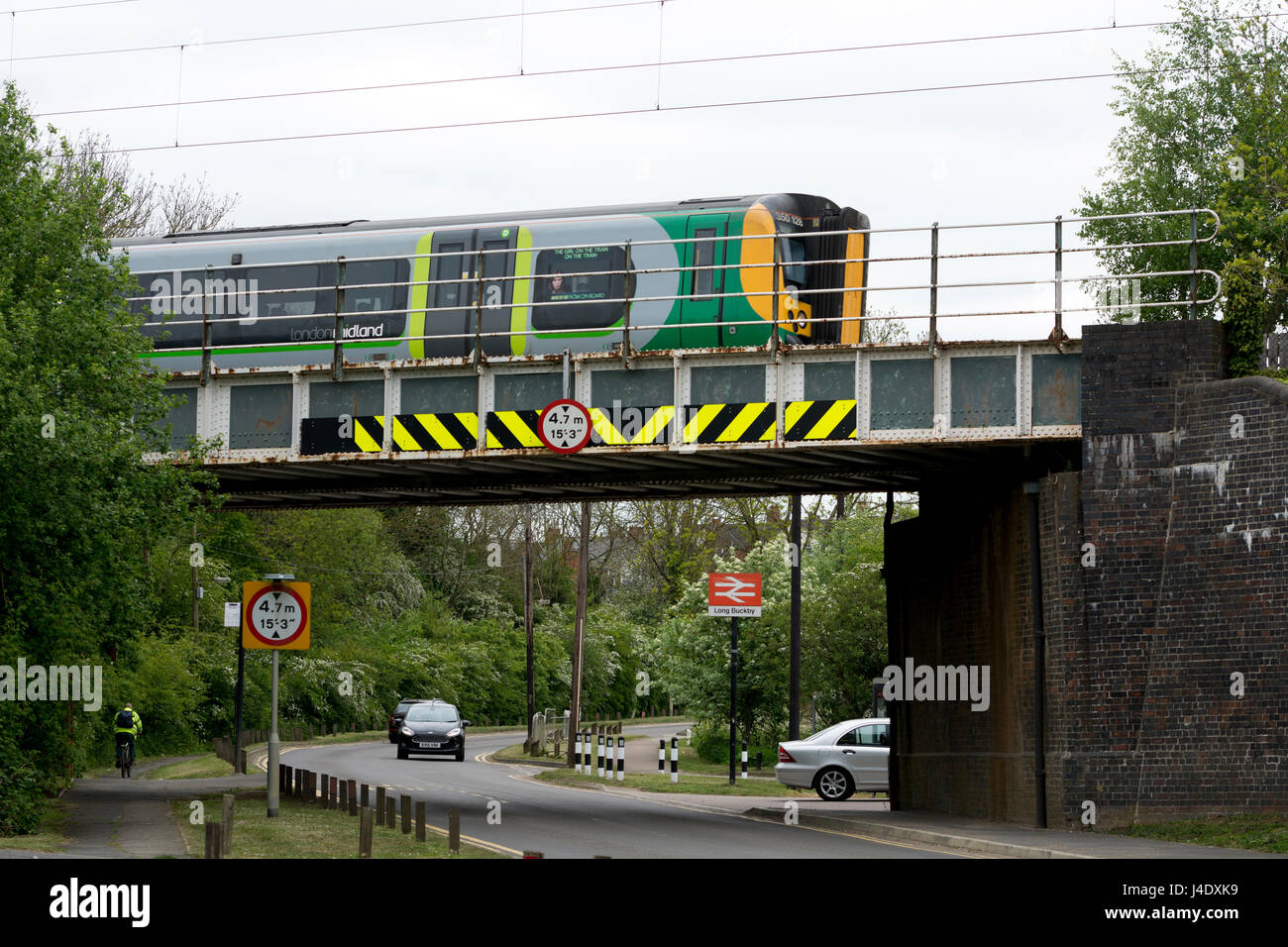 London Midland train crossing a railway bridge by Long Buckby station ...