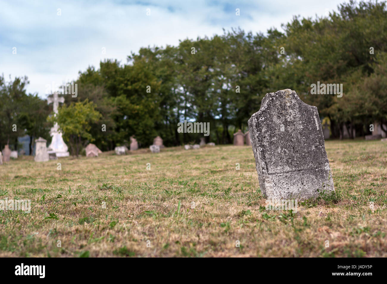 Weathered tombstone in an old 19th century german cemetery in Budajeno ...