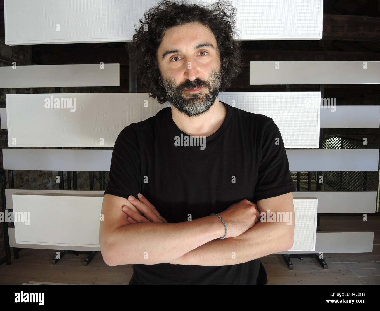 Turkish artist Cevdet Erek standing in front of his installation in the ...