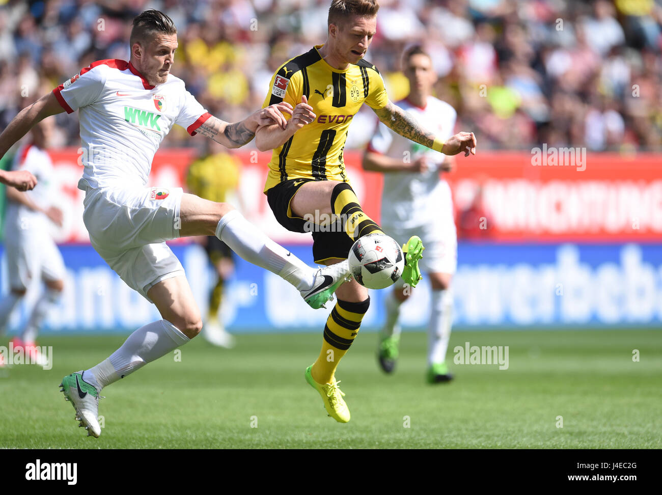 Augsburg, Germany. 13th May, 2017. Augsburg's Jeffrey Gouweleeuw and ...