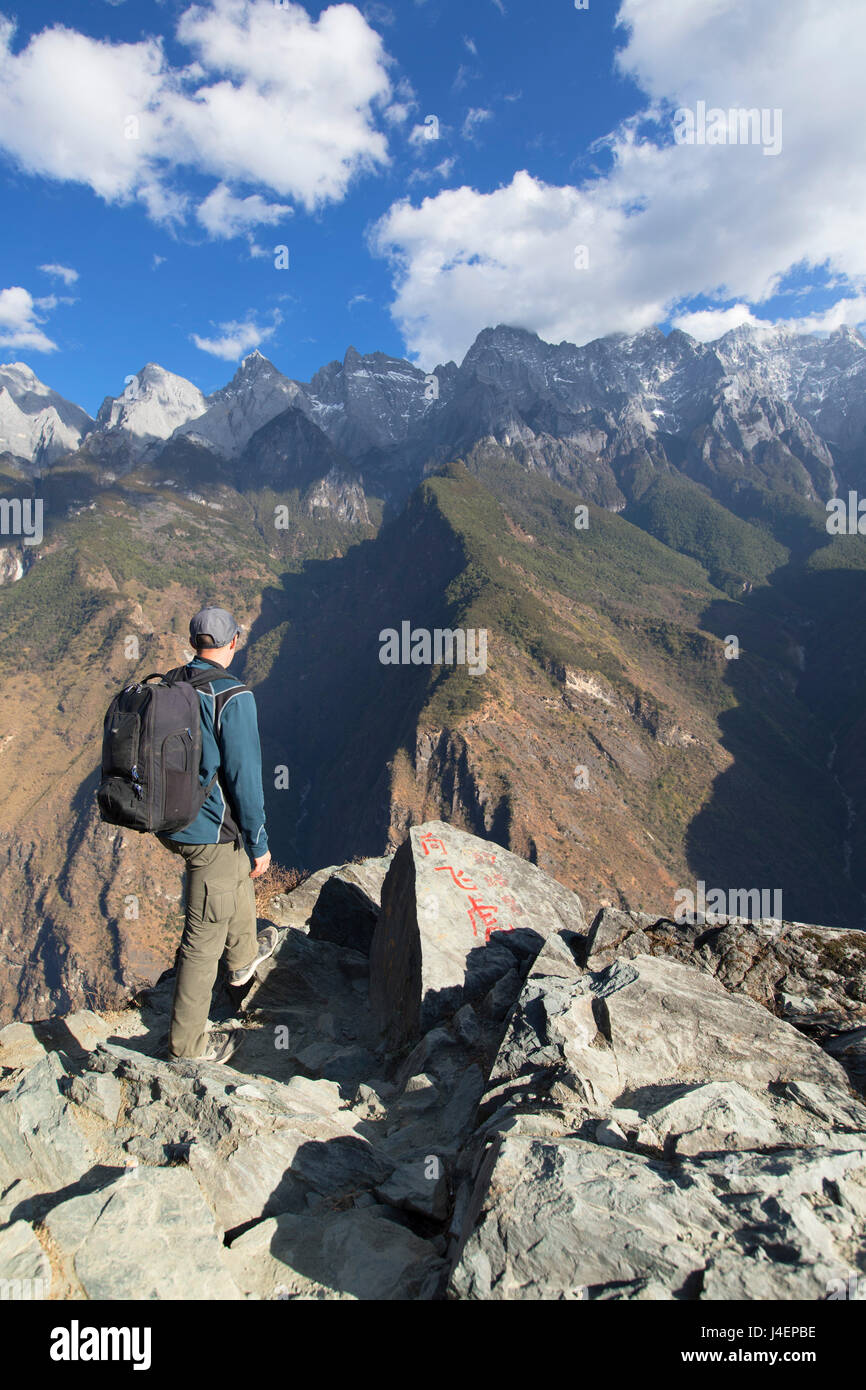Man hiking in Tiger Leaping Gorge, UNESCO, with Jade Dragon Snow ...