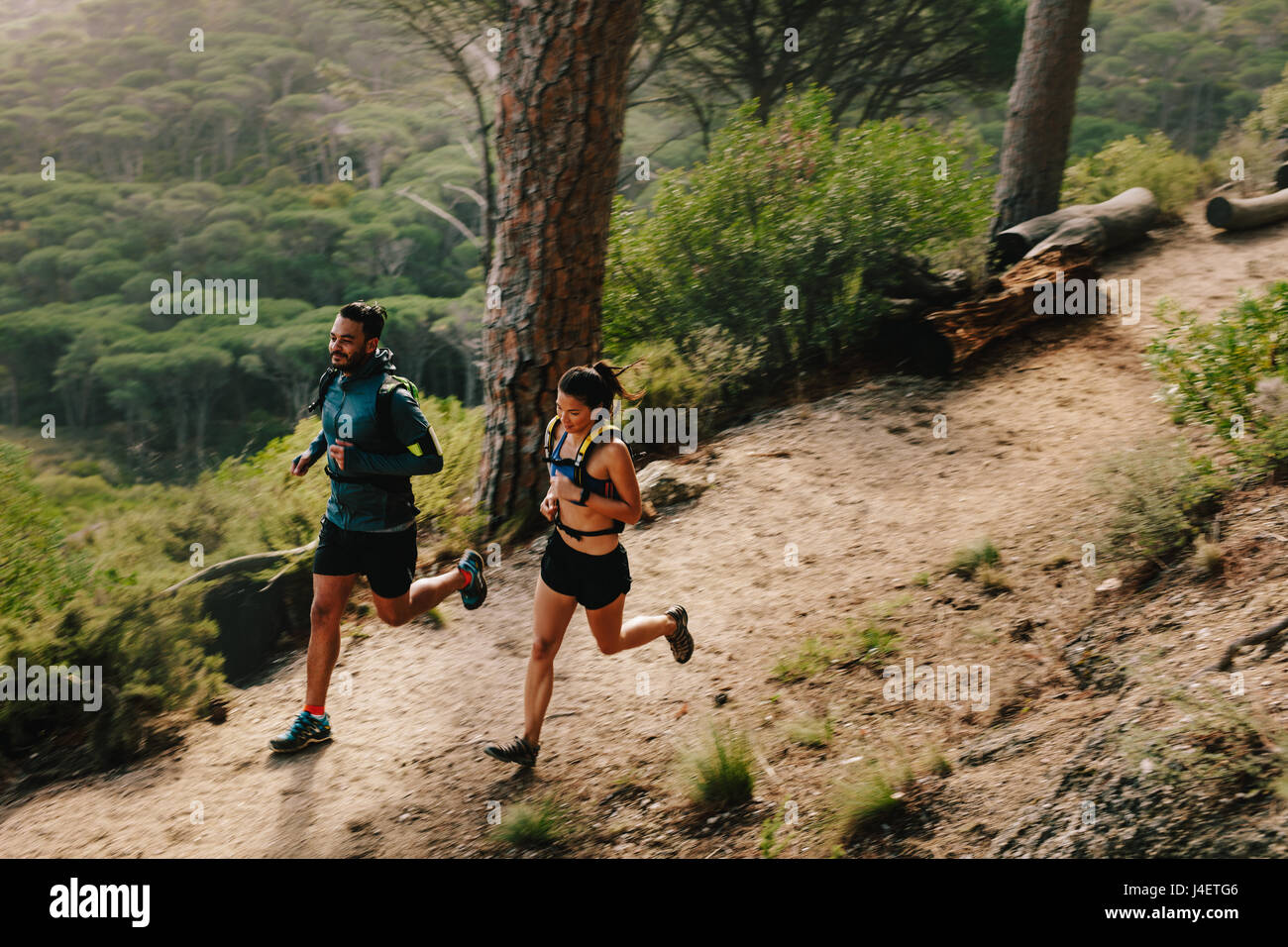 Young couple running on country trail. Young man and woman running ...