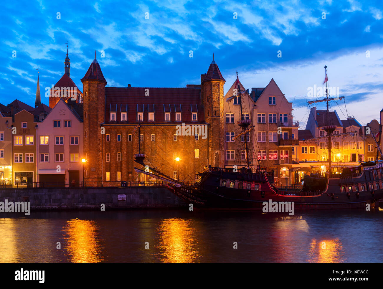 Night in Gdansk - old town waterfront with sailing ship illuminated in ...