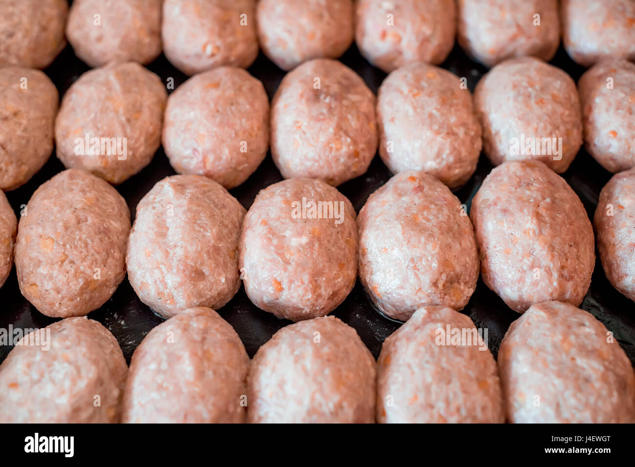 Many unprepared juicy cutlets of raw meat Stock Photo - Alamy