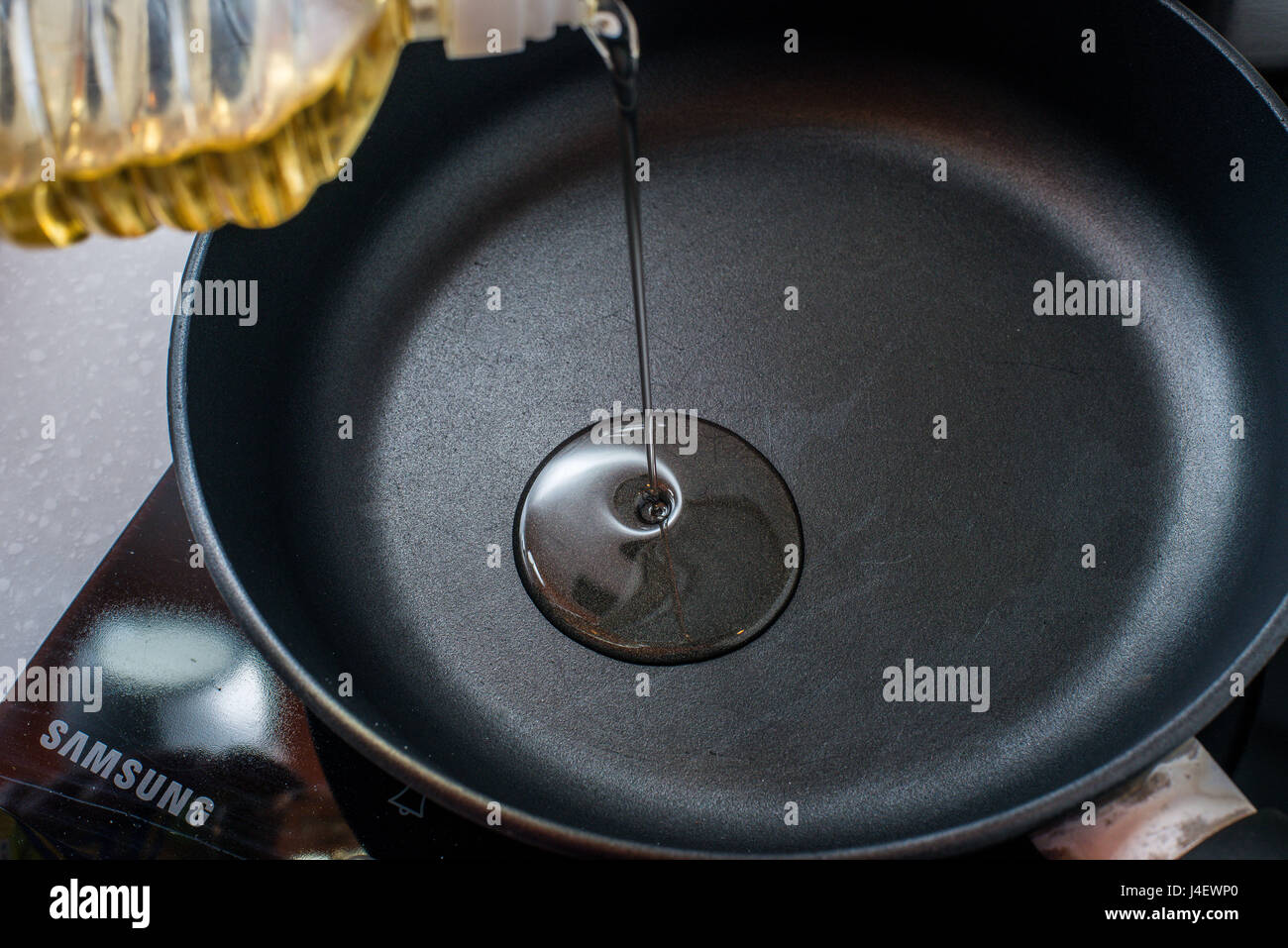 Chef pouring vegetable oil to the pan Stock Photo - Alamy