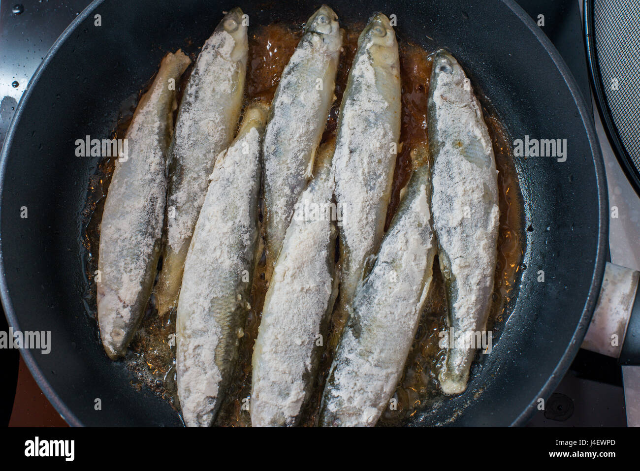 Fried small smelt tasty fish on a barbecue grill hotplate Stock Photo ...